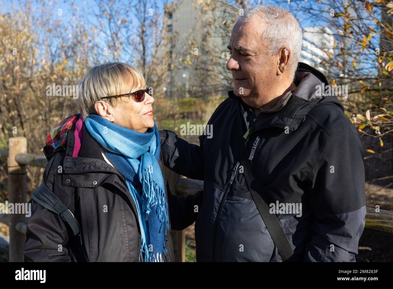 Senior couple gazing lovingly at each other in a park Stock Photo - Alamy