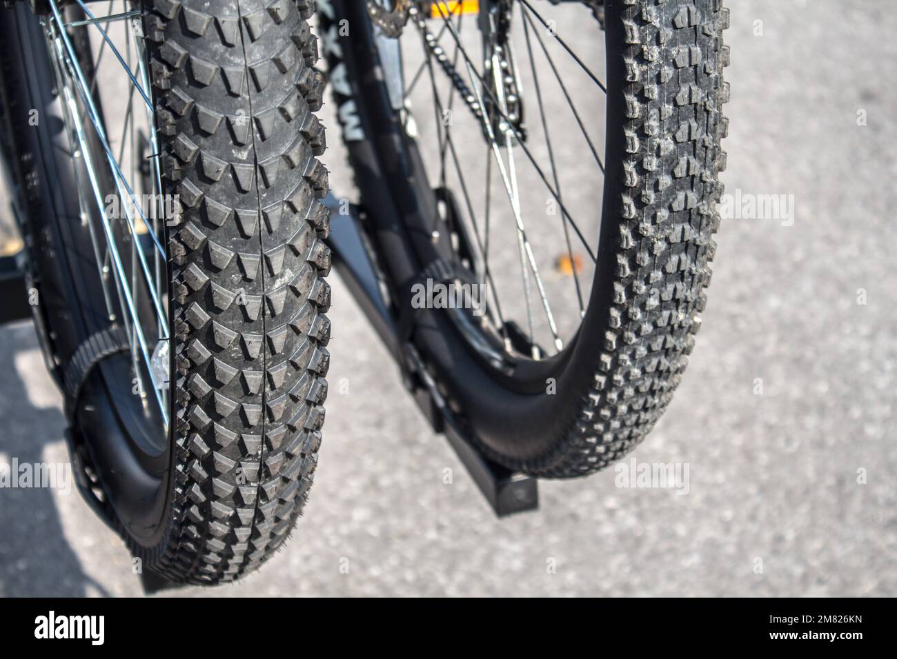 Closeup of two mountain bike wheel tires on grey background. Travel ...