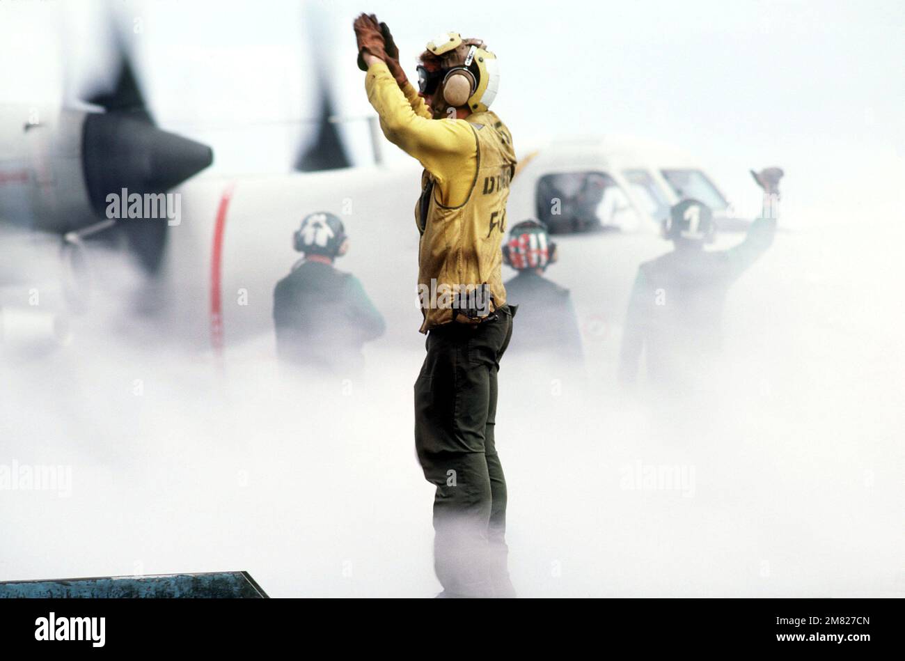Flight deck crewman prepare an E-2 Hawkeye Airborne Early Warning ...