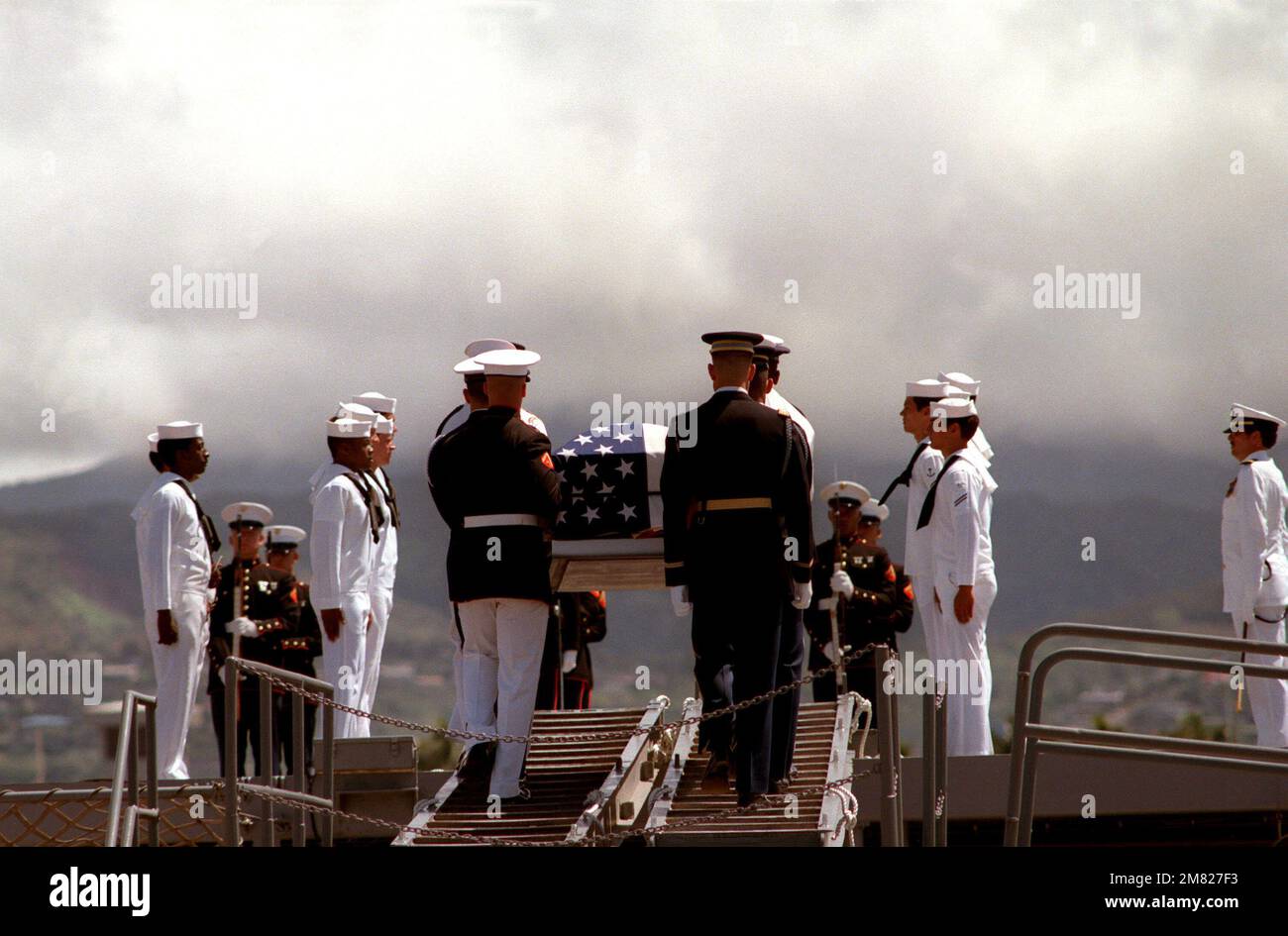 A joint services casket team carries the flag-draped casket of the ...