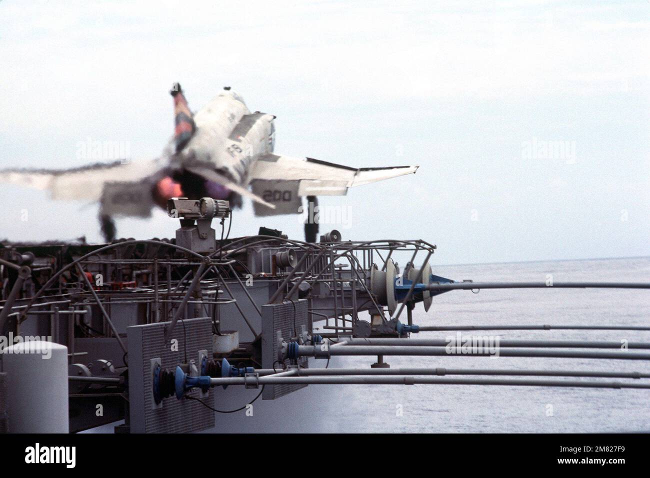 An F-4 Phantom II aircraft lifts off from the aircraft carrier USS ...