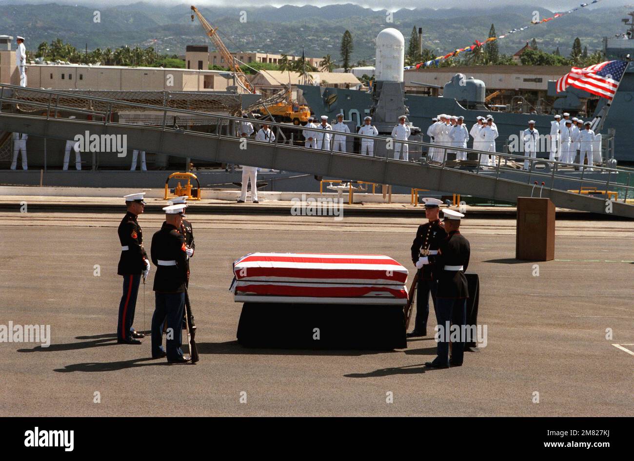 A Marine Corps honor guard stands around the flag draped casket of the ...