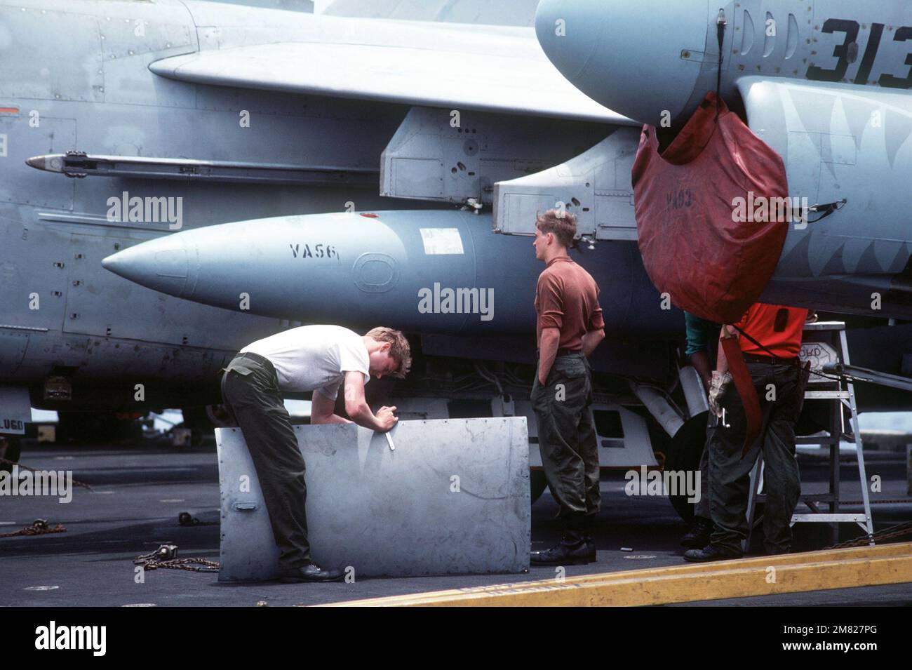 Members of Light Attack Squadron 56 (VA-56) perform maintenance on an A ...
