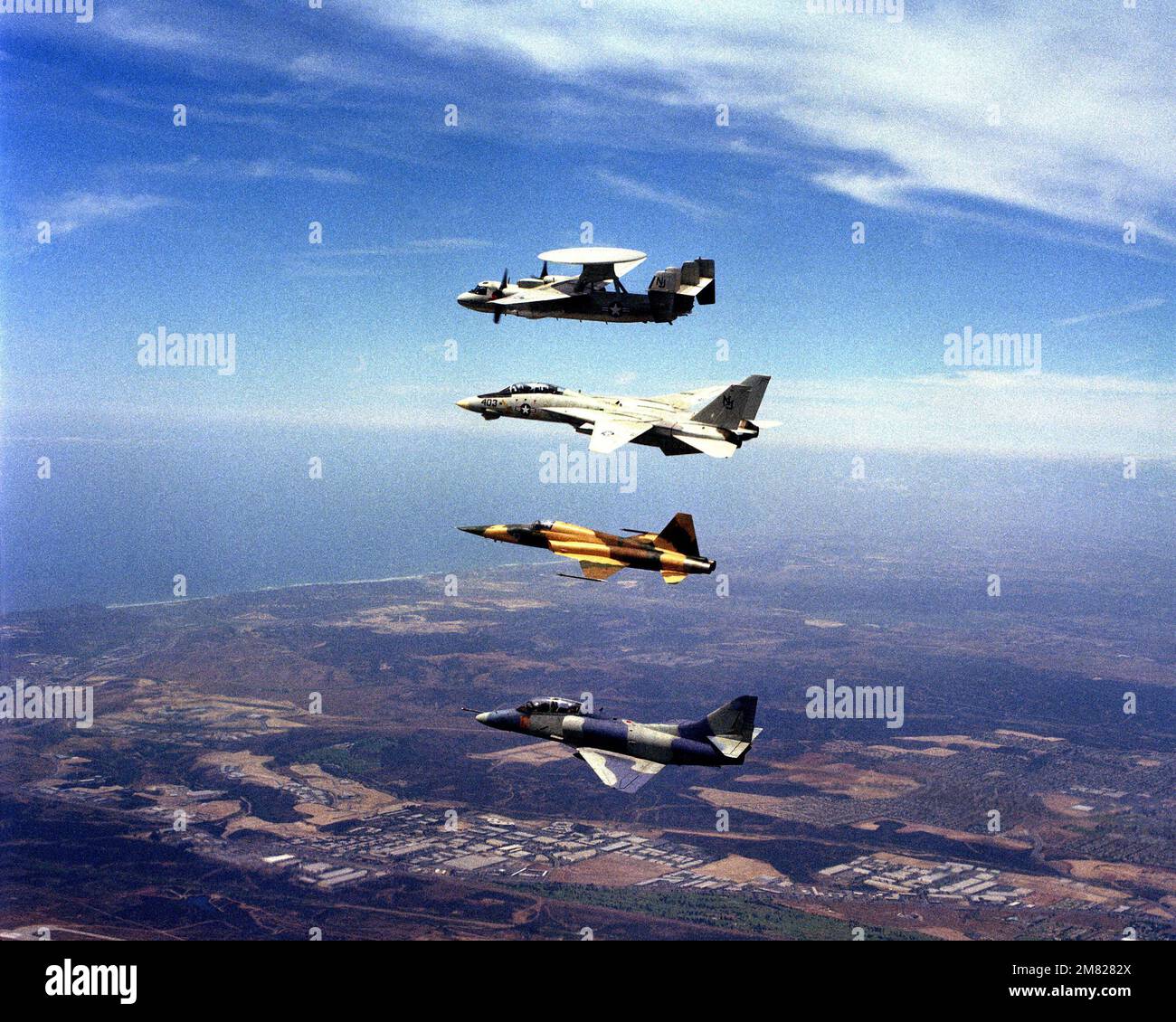 An air-to-air left side view (from top to bottom) of an E-2C Hawkeye ...