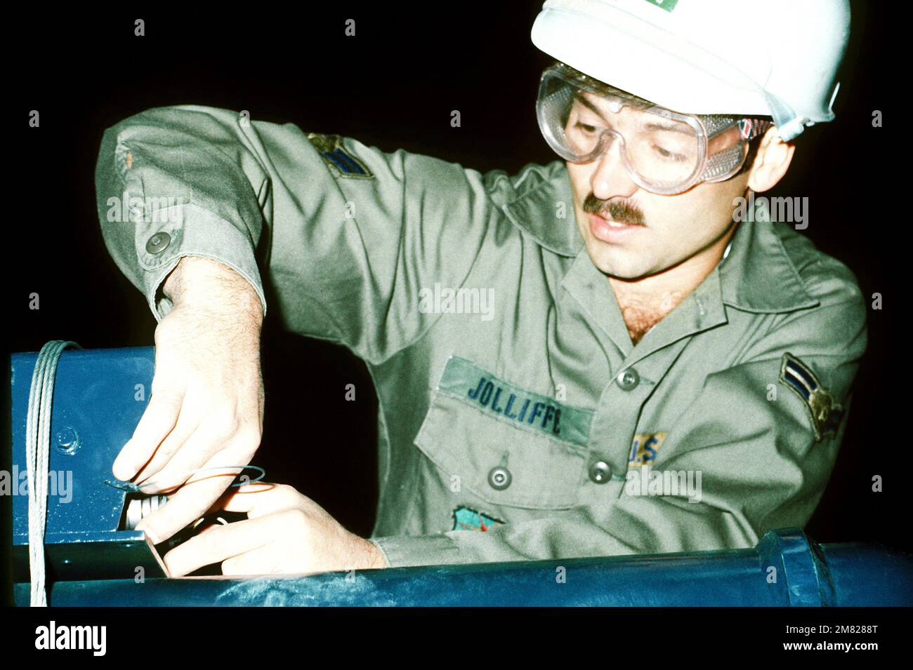 A1C Timothy L. Jolliffe, 390th Missile Maintenance Squadron, caps the ...