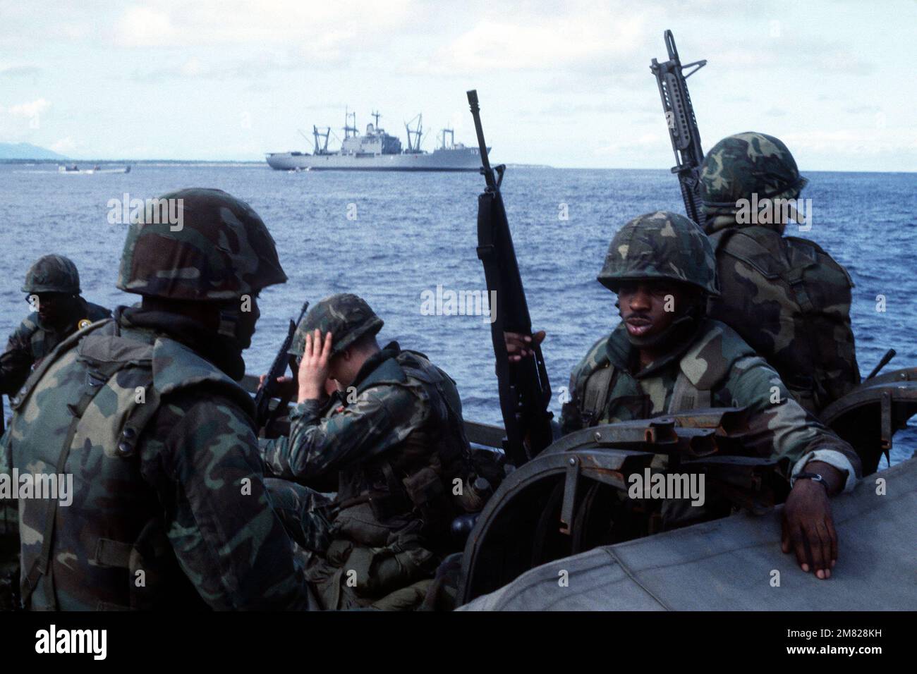 Troops armed with M16A1 rifles and M60 machine guns prepare to go ...