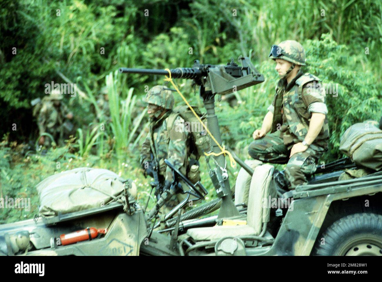 A soldier mans an M2 .50-caliber machine gun mounted in a jeep during ...