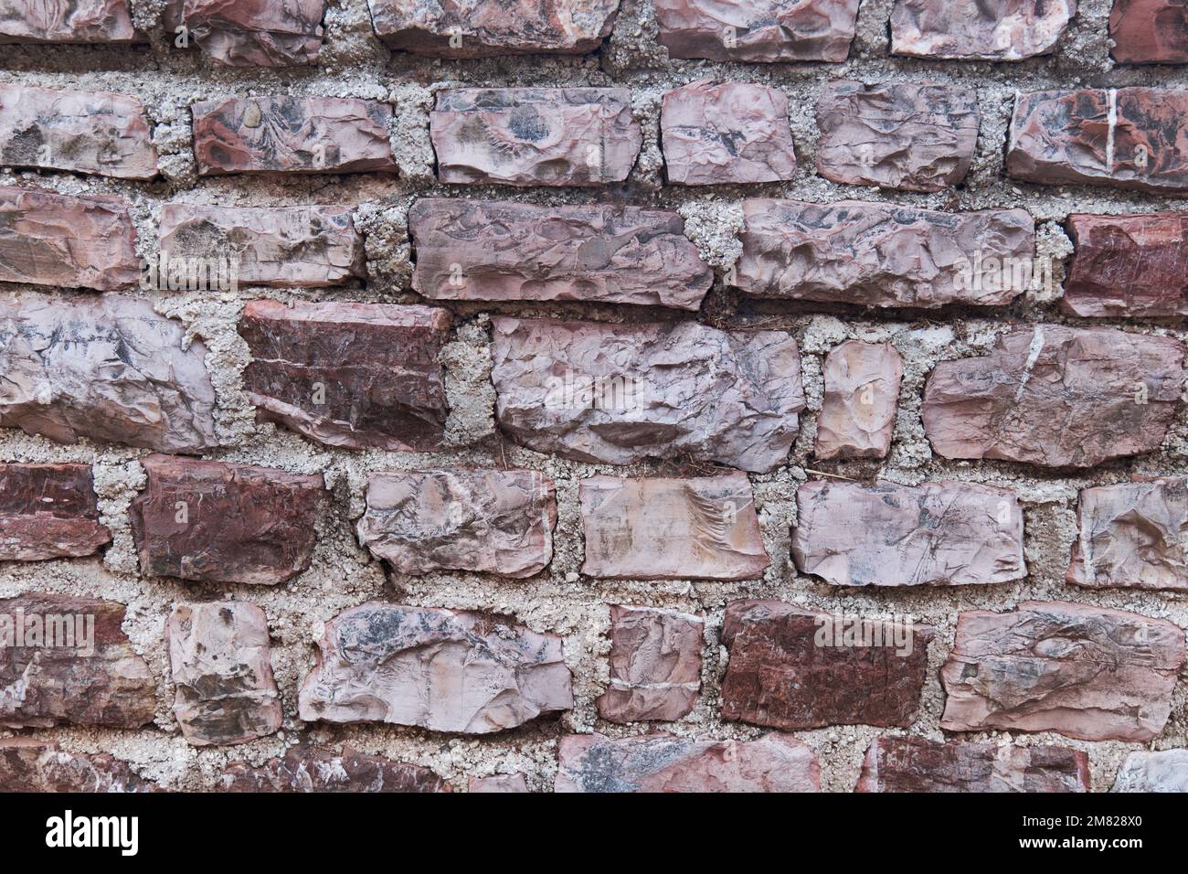 A brown brick wall. Repeated background of the Stone Wall Stock Photo ...
