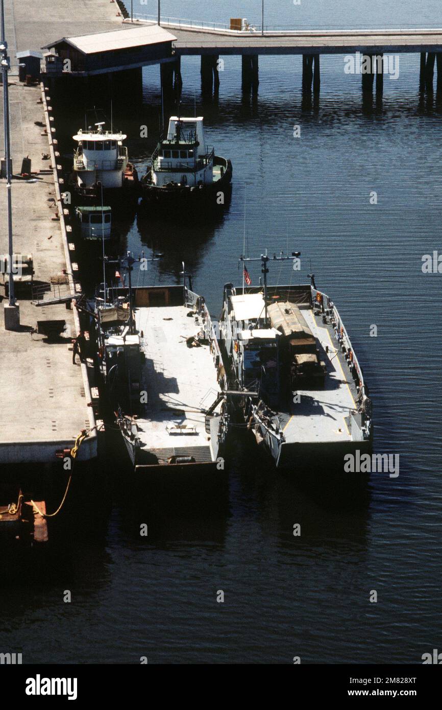 An aerial view of docked tug boats and landing craft in use during the ...
