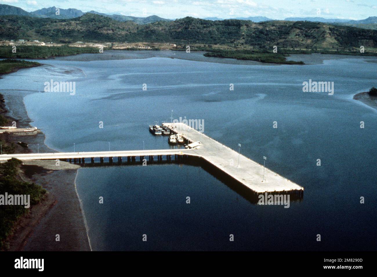 An aerial view of docked tug boats and landing craft in use during the ...