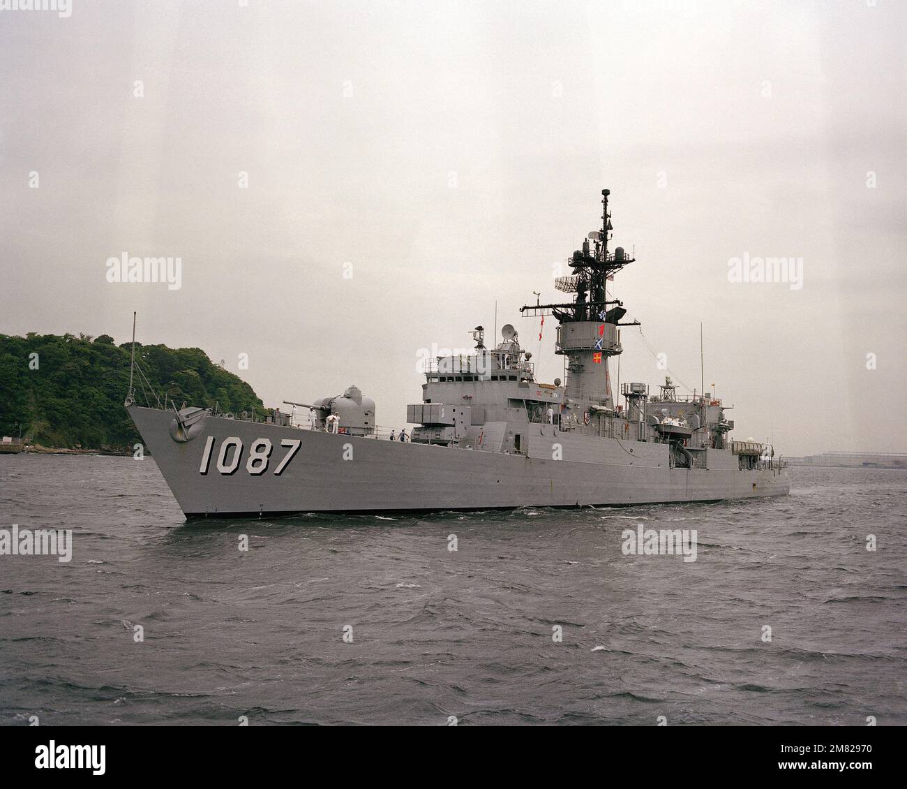 A port bow view of the frigate USS KIRK (FF 1087) entering port at ...
