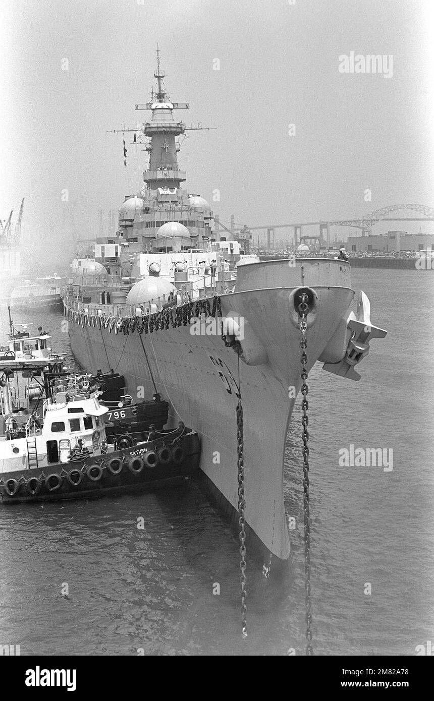 The large harbor tug USS SACO (YTB 796) and two commercial tugs guide ...