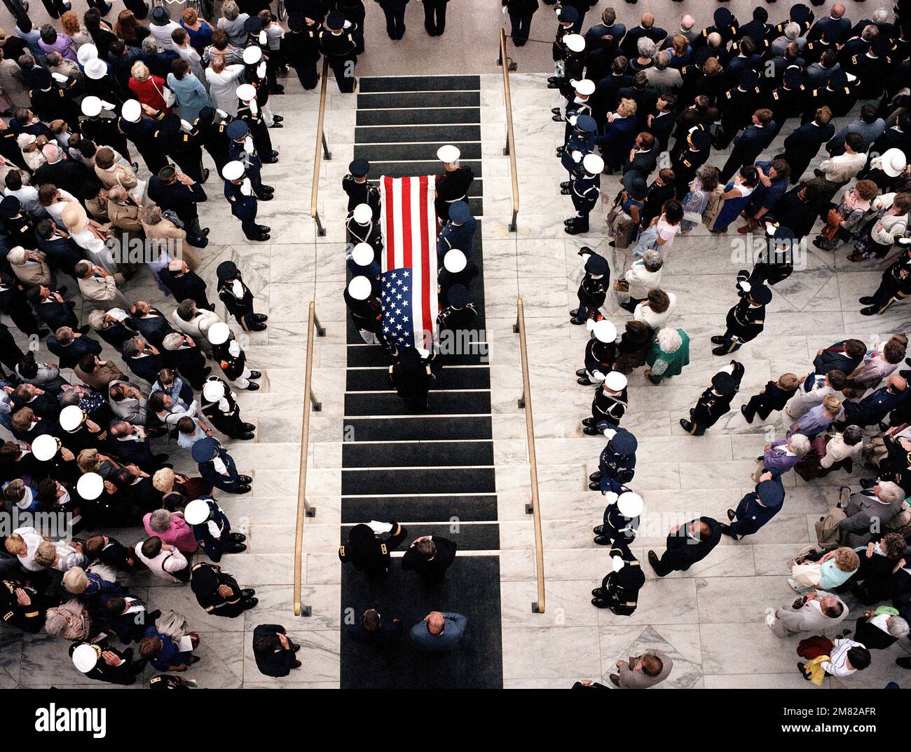 A joint services casket team carries the flag-draped casket of the ...