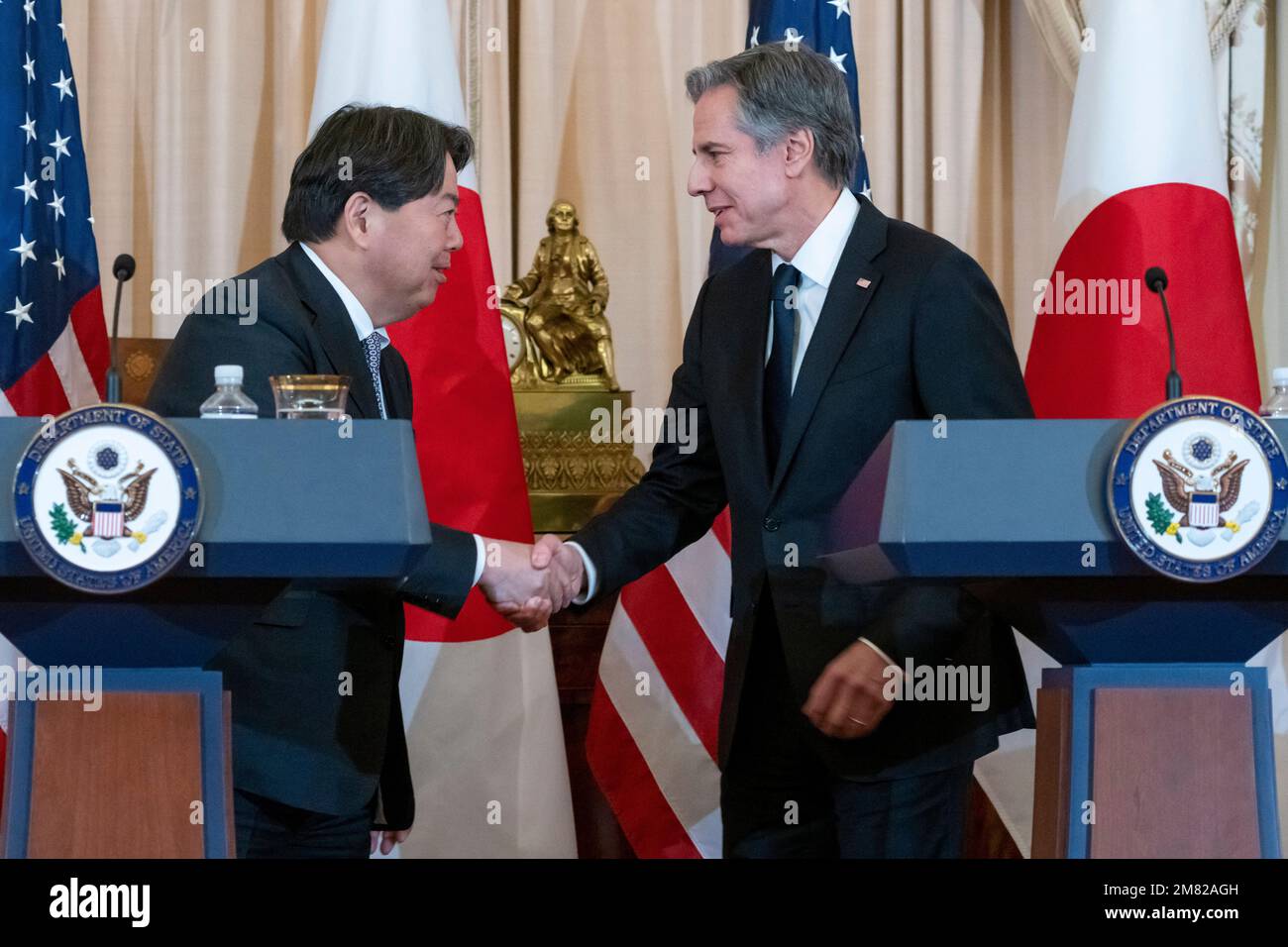 Japanese Foreign Minister Hayashi Yoshimasa, left, shakes hands with ...