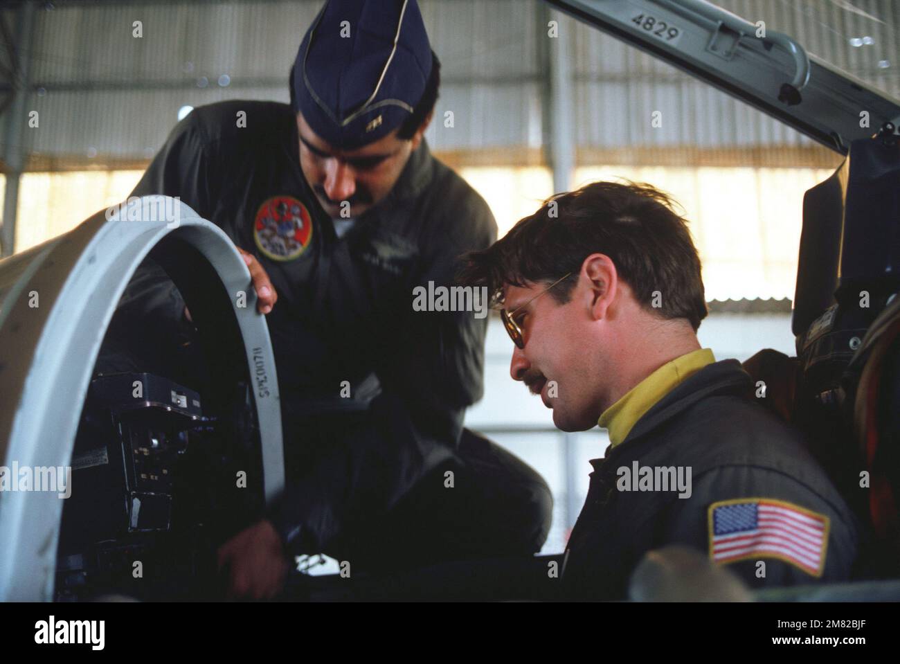 A Brazilian F-5 pilot, left, explains the layout of the aircraft's ...