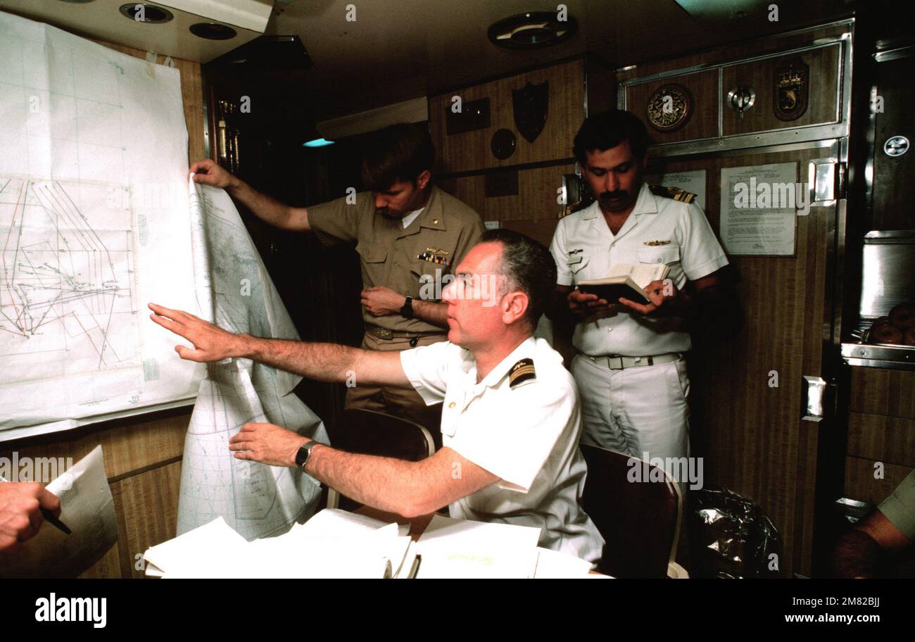Officers conduct a submarine pre-sail conference in the wardroom aboard ...