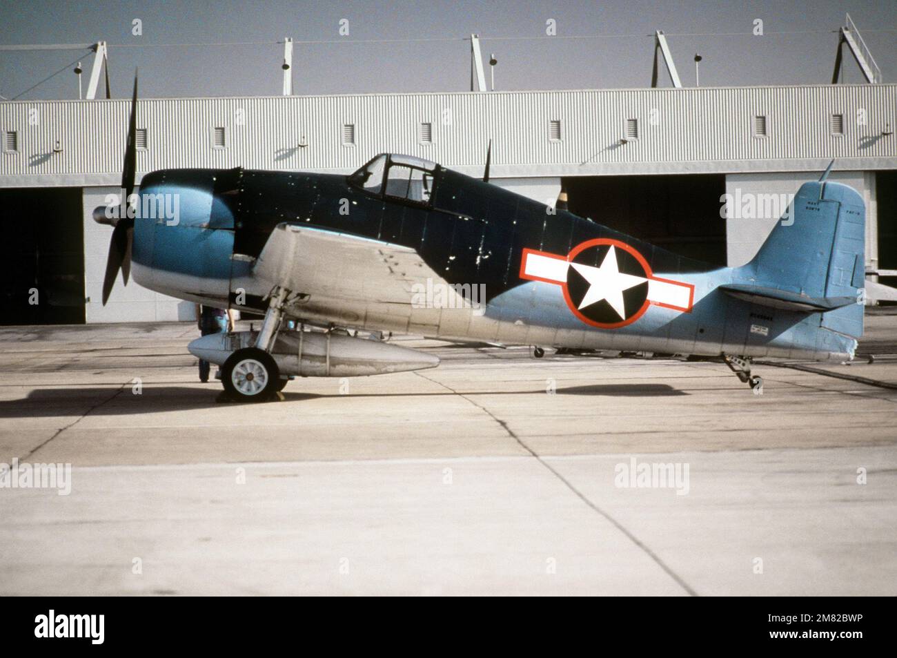 Left side view of a restored F-6F Hellcat aircraft parked on the flight ...