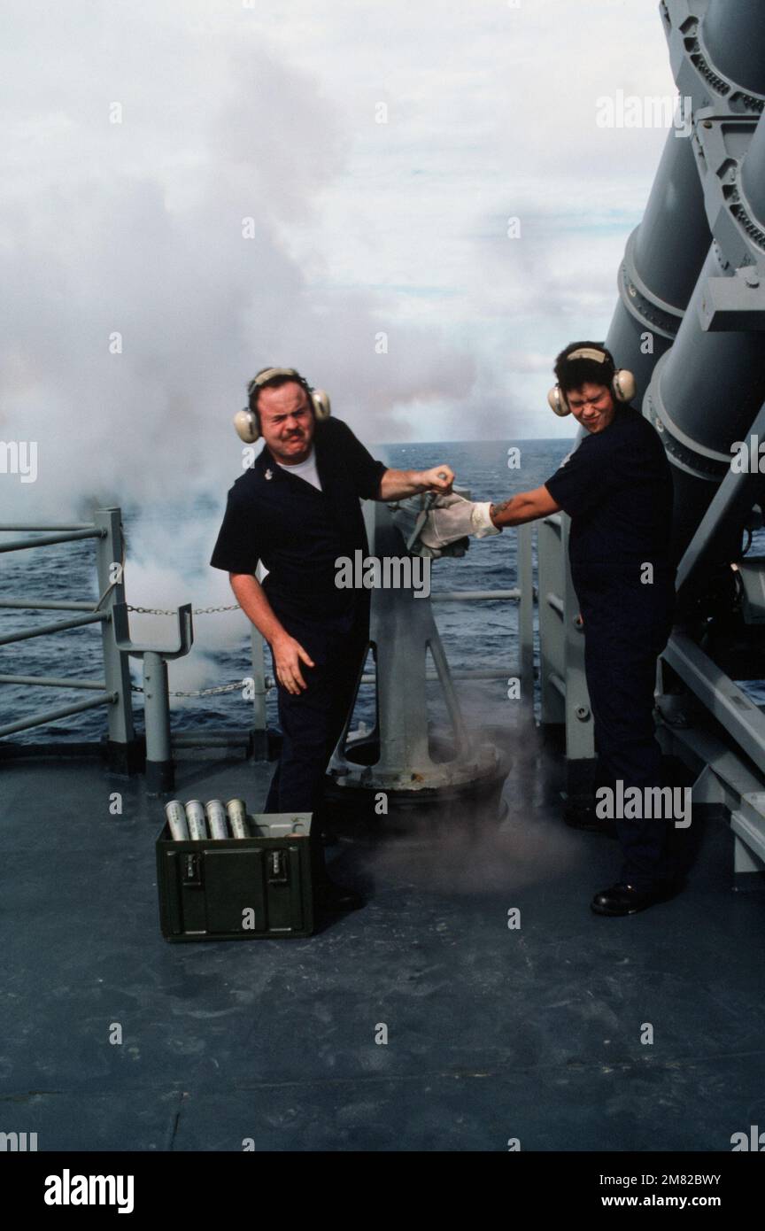 Crewmen aboard the destroyer USS THORN (DD 988) fire a gun salute as ...