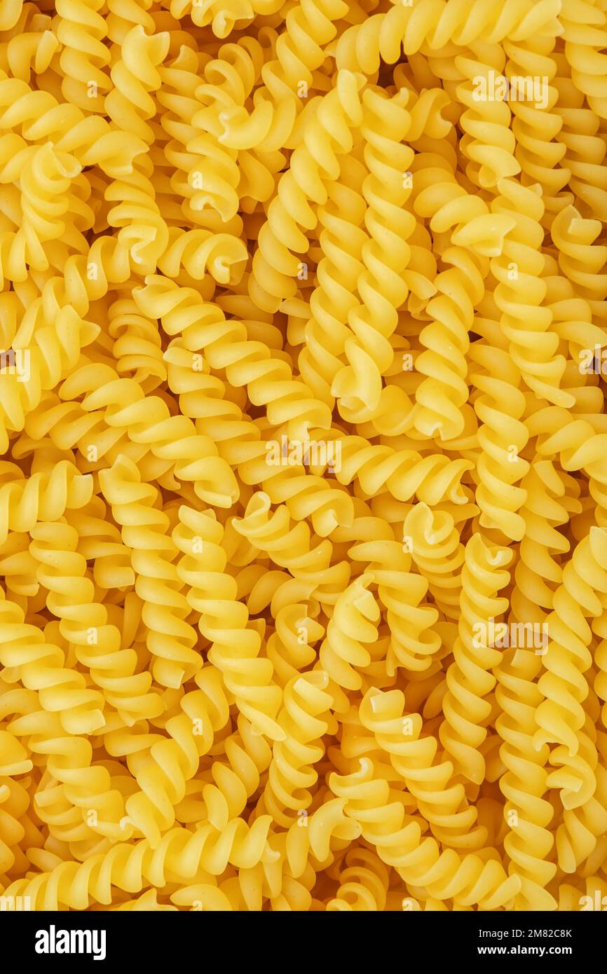 Raw dry fusilli pasta, food background texture, top view Stock Photo ...