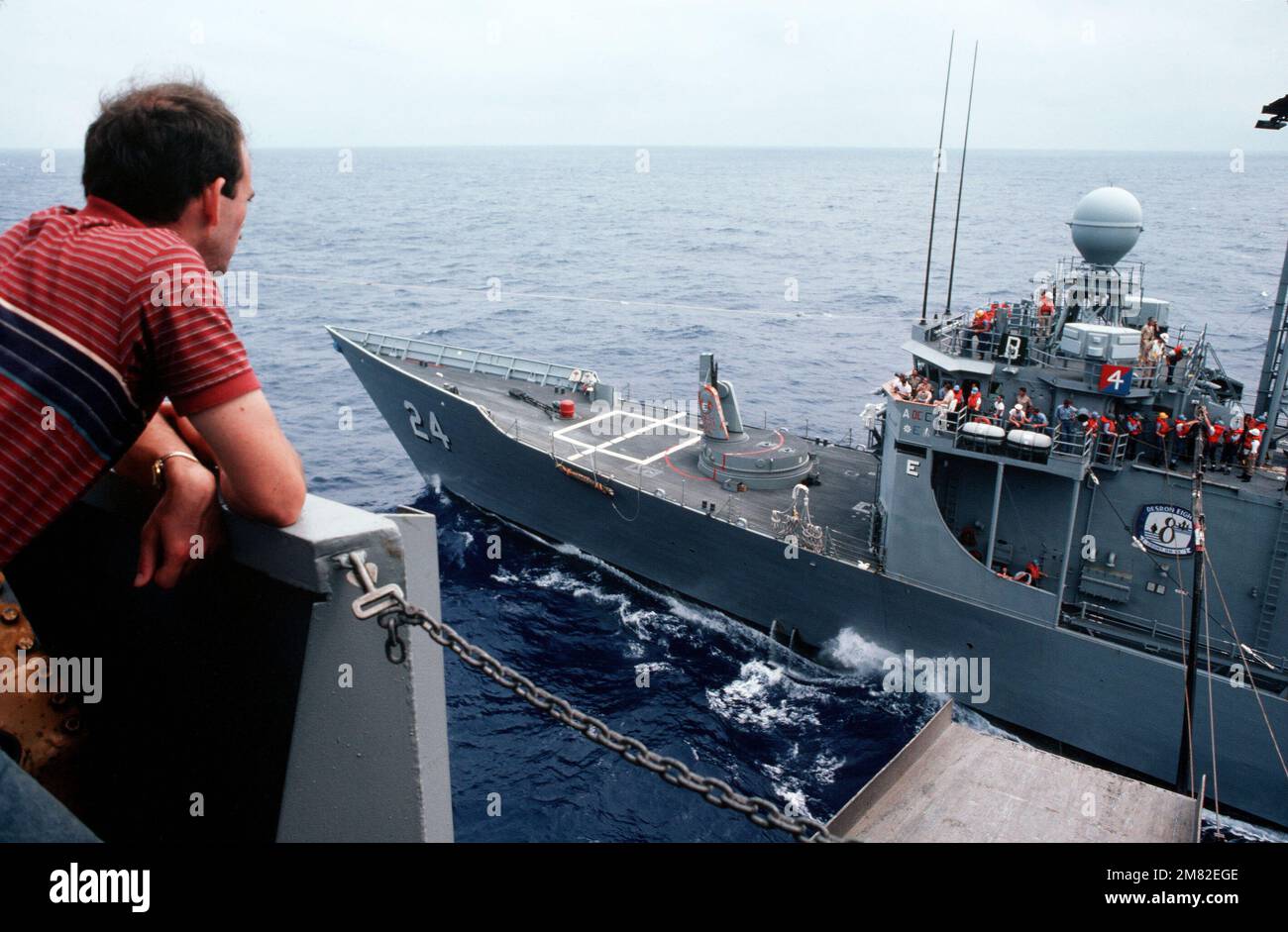 The guided missile frigate USS JACK WILLIAMS (FFG 24) cruises alongside ...