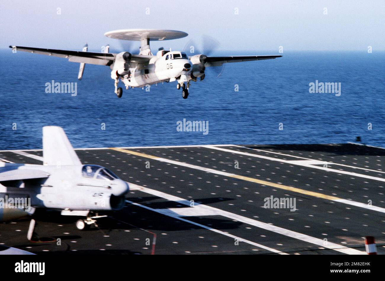 An E-2C Hawkeye airborne early warning aircraft comes in for a landing ...