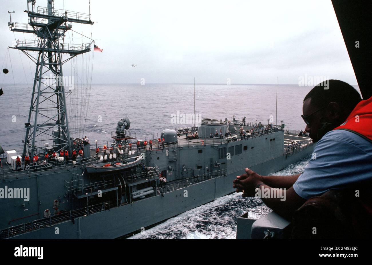 A sailor aboard the aircraft carrier USS JOHN F. KENNEDY (CV 67) looks ...