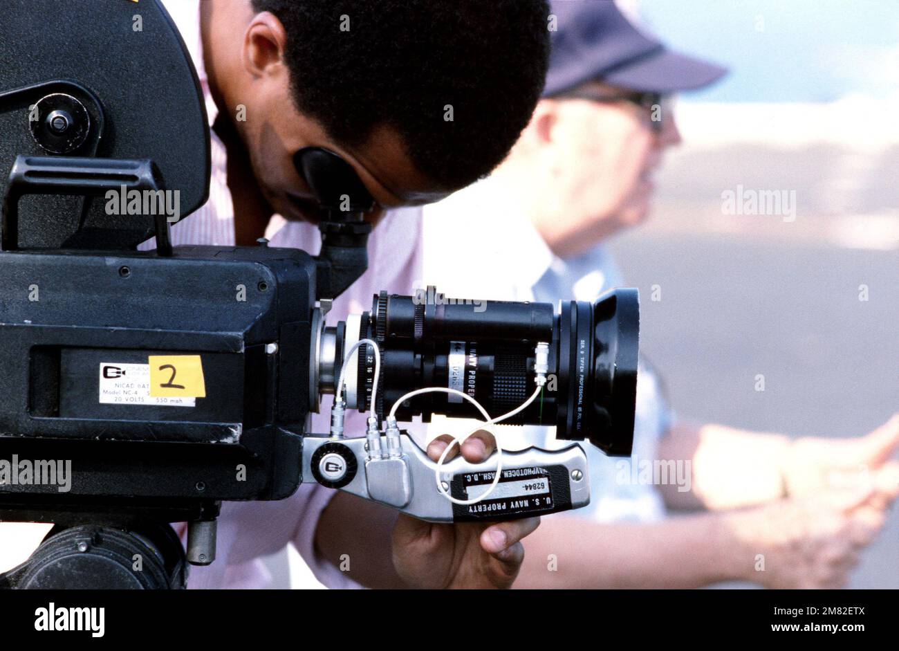 A member of the Naval Audiovisual Center NAVC) motion picture crew ...
