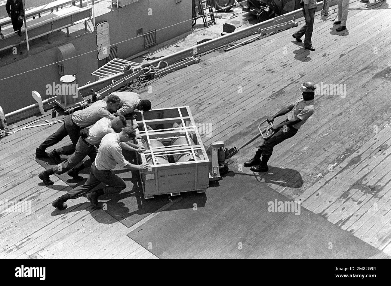 Crewmen aboard the battleship USS IOWA (BB-61) work to move 16-inch ...