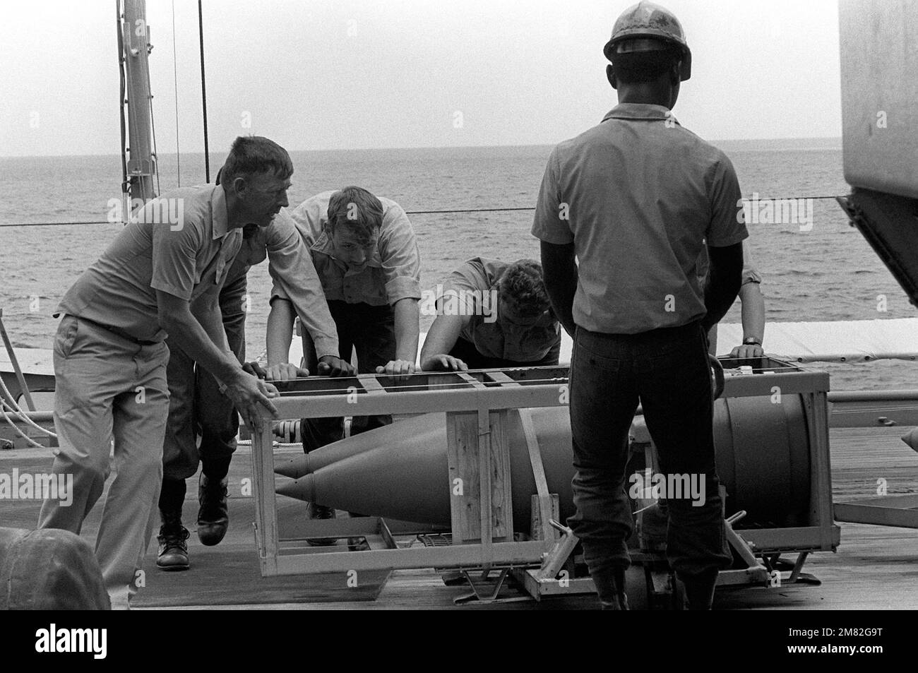 Crewmen aboard the battleship USS IOWA (BB-61) work to move 16-inch ...