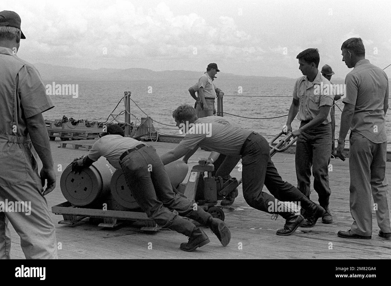 Crewmen aboard the battleship USS IOWA (BB-61) work to move 16-inch ...