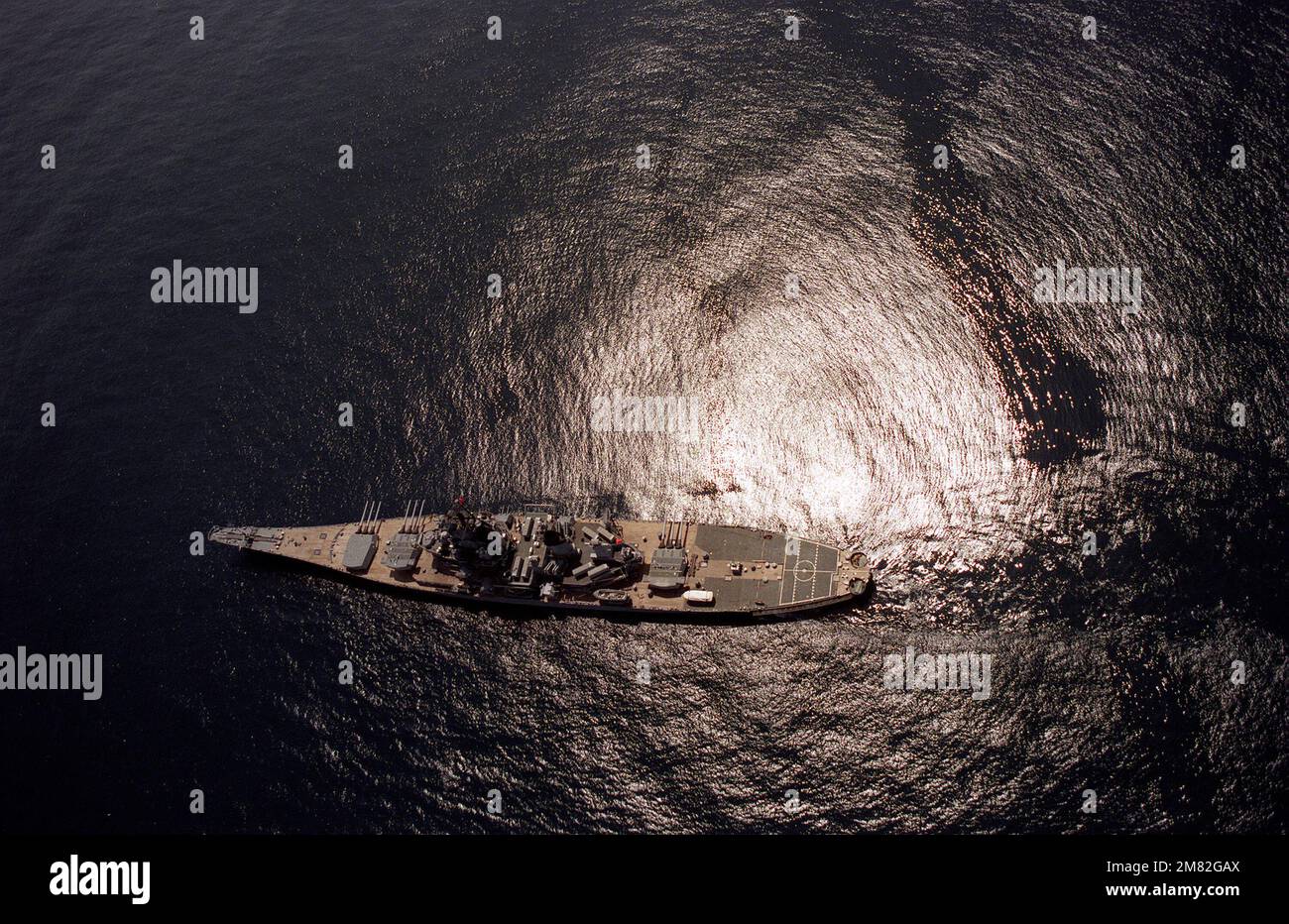 An overhead view of the battleship USS IOWA (BB-61) with its guns ...