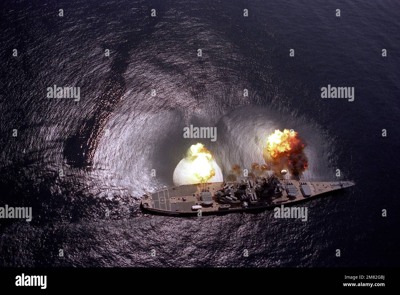 An Overhead View Of The Battleship Uss Iowa Bb 61 Firing A 15 Gun Broadside To Starboard