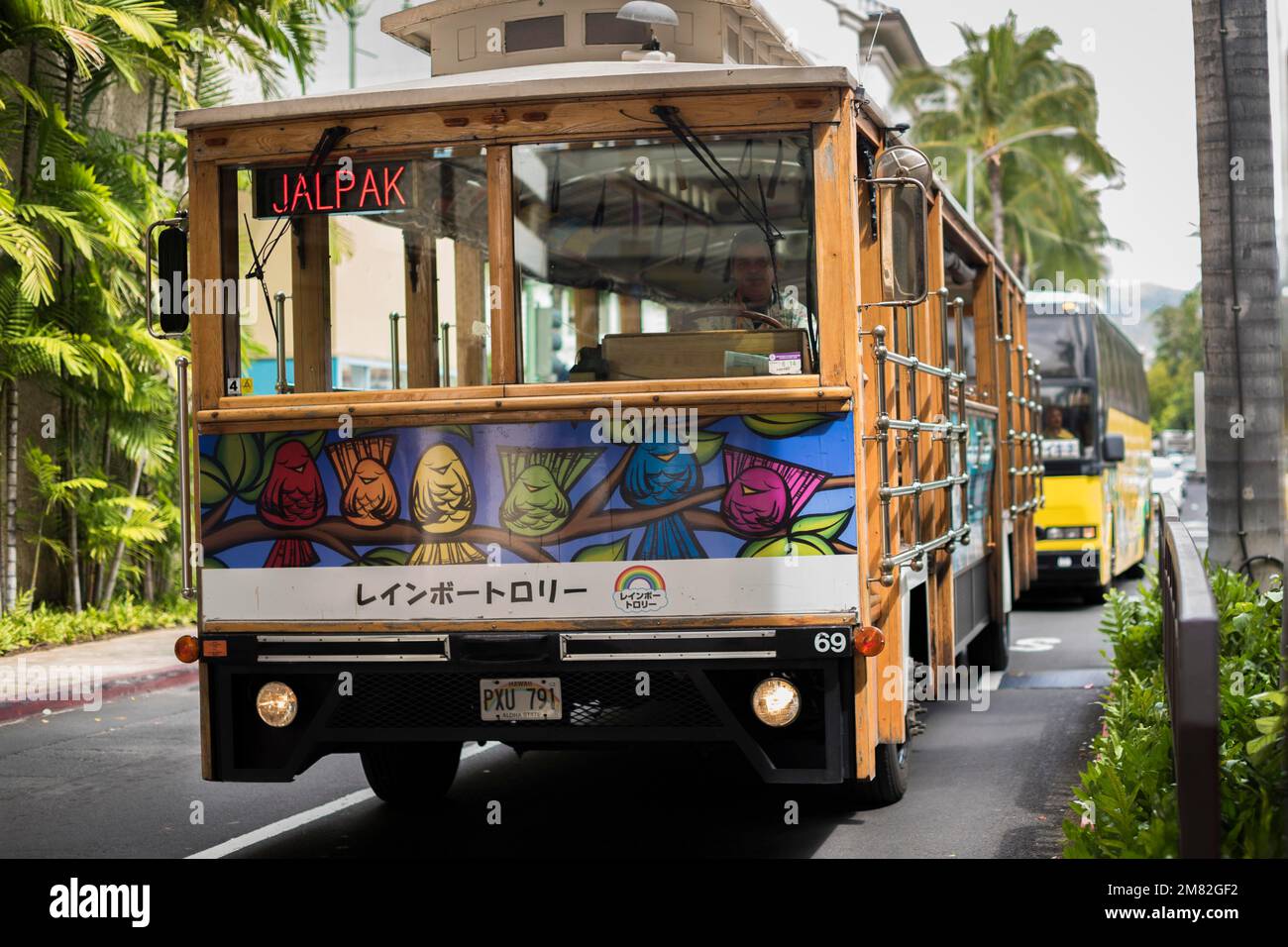 Waikiki Trolley in the streets of Oahu. The front of it shows Heather ...