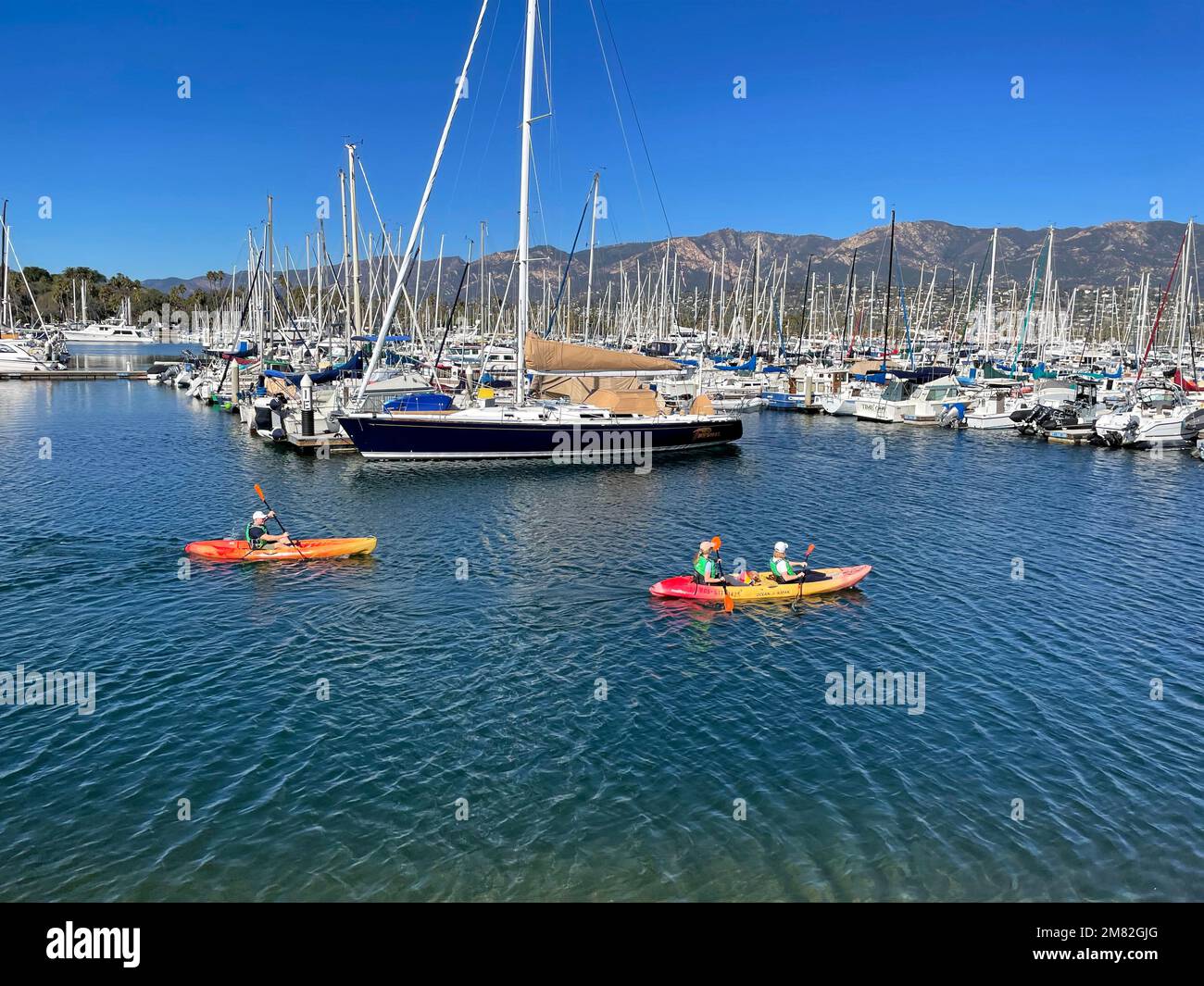 People in colorful kayaks visiting the boat harbor in Santa Barbara ...