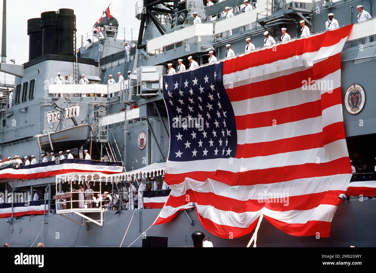 The crew of the Aegis guided missile cruiser USS YORKTOWN (CG 48) man ...