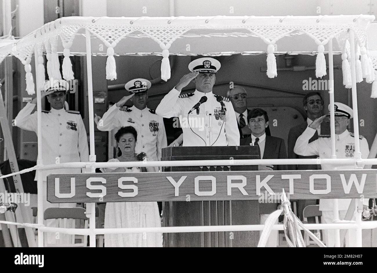 Distinguished guests on the speakers platform salute during the ...
