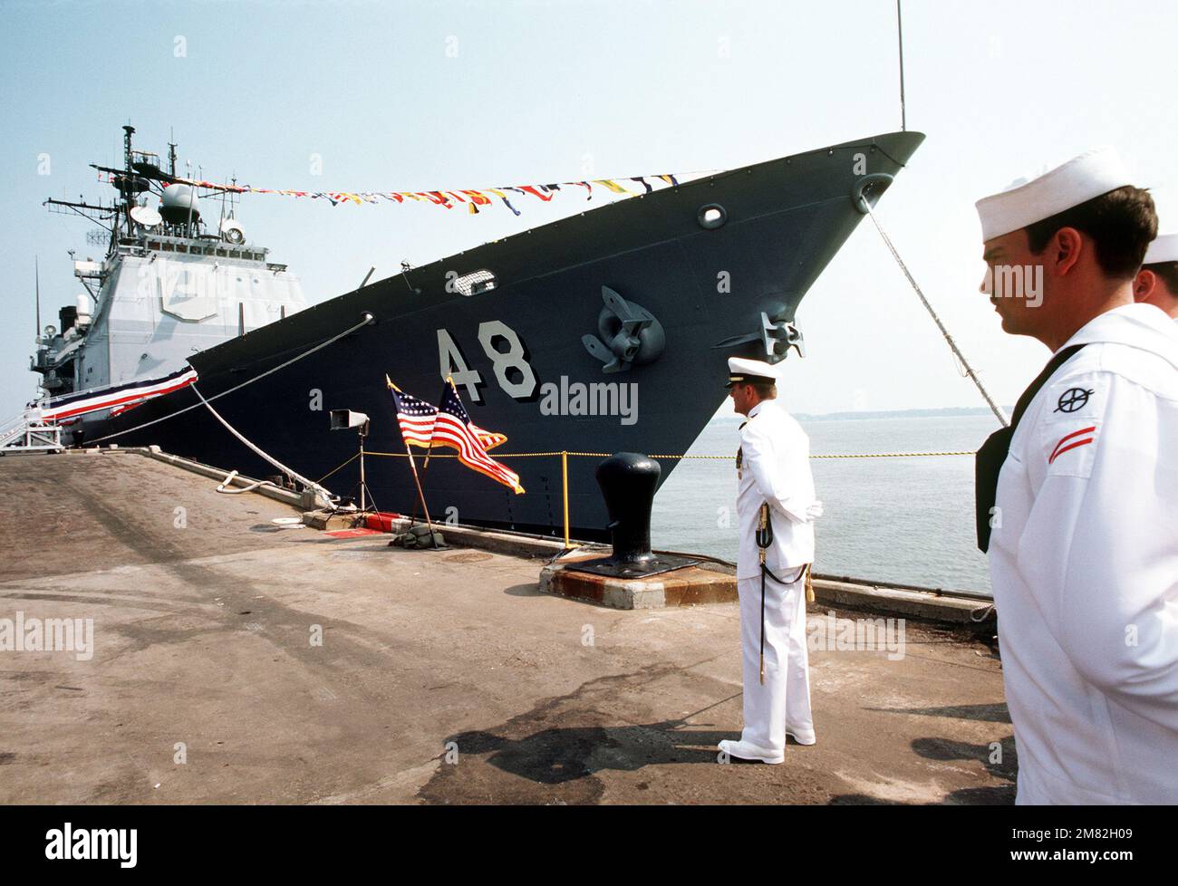 Crewmen of the Aegis guided missile cruiser USS YORKTOWN (CG 48) stand ...