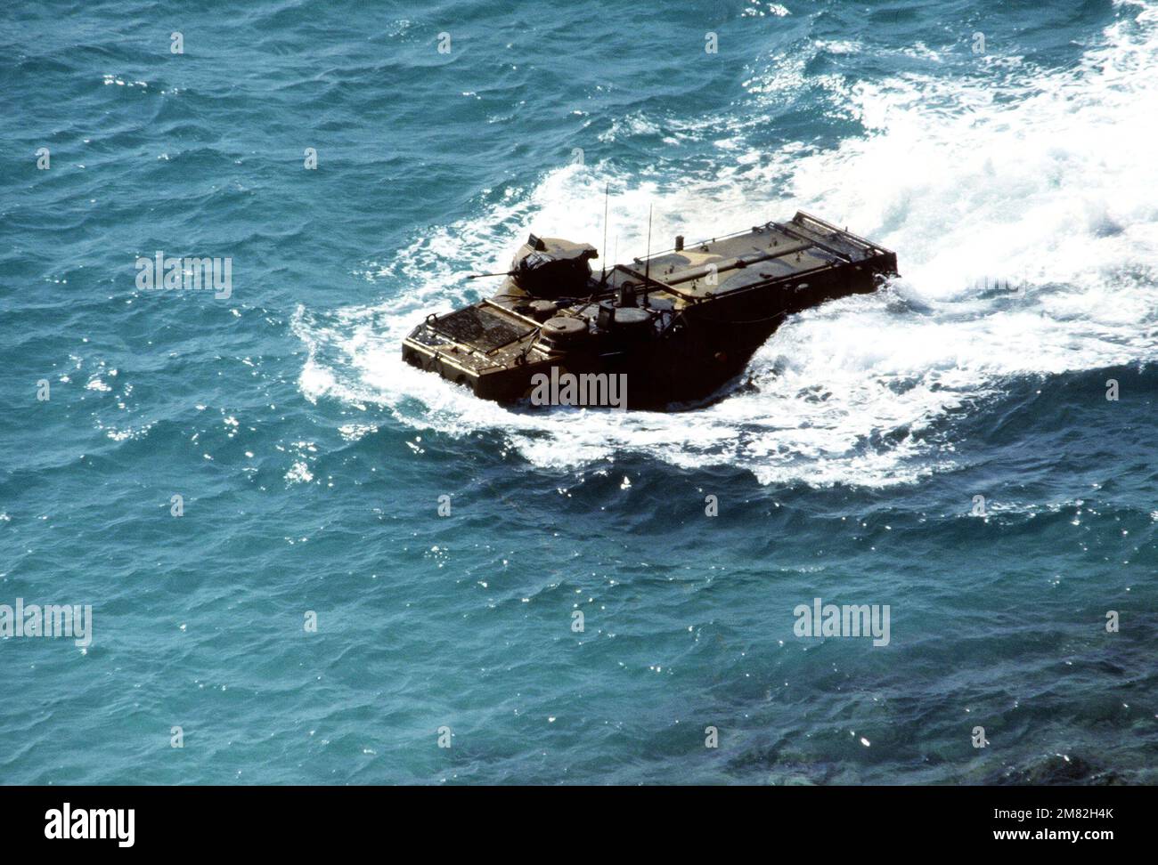 A US Marine Corps AAVP-7 amphibious assault vehicle plows through the ...