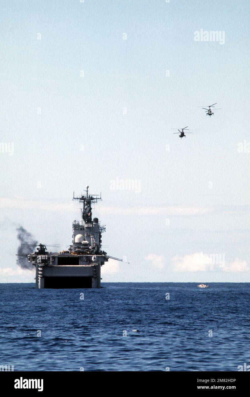 A stern view of the amphibious cargo ship USS NASSAU (LHA 4) as two CH ...
