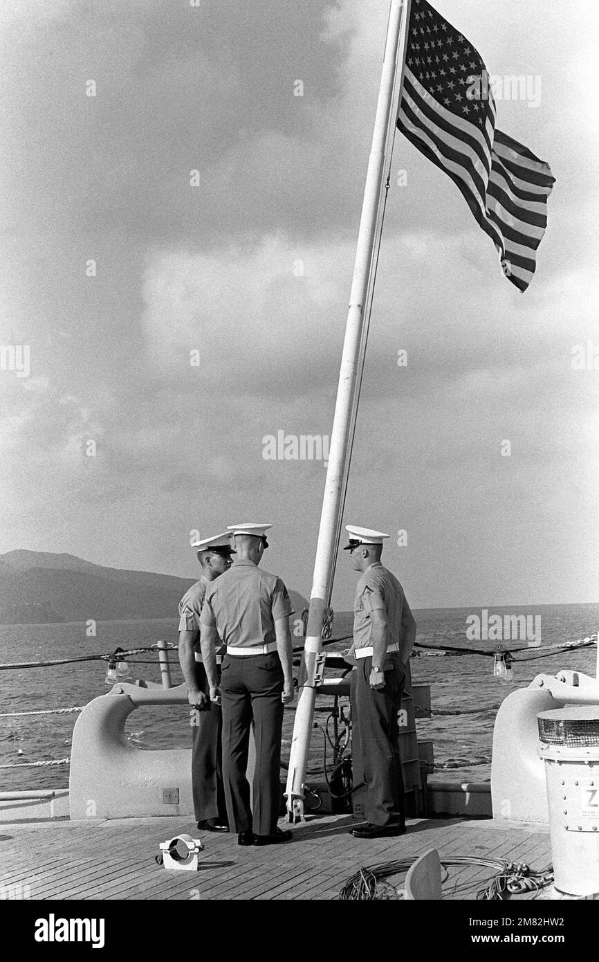 A Marine color guard aboard the battleship USS IOWA (BB-61) raises the ...
