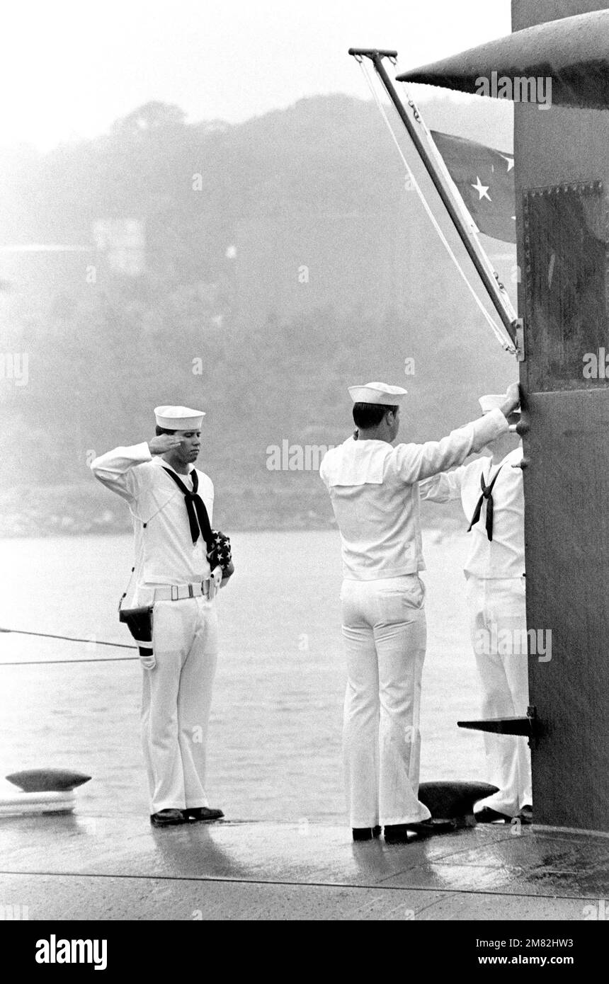 Crewmen raise an admiral's flag aboard the nuclear-powered attack ...