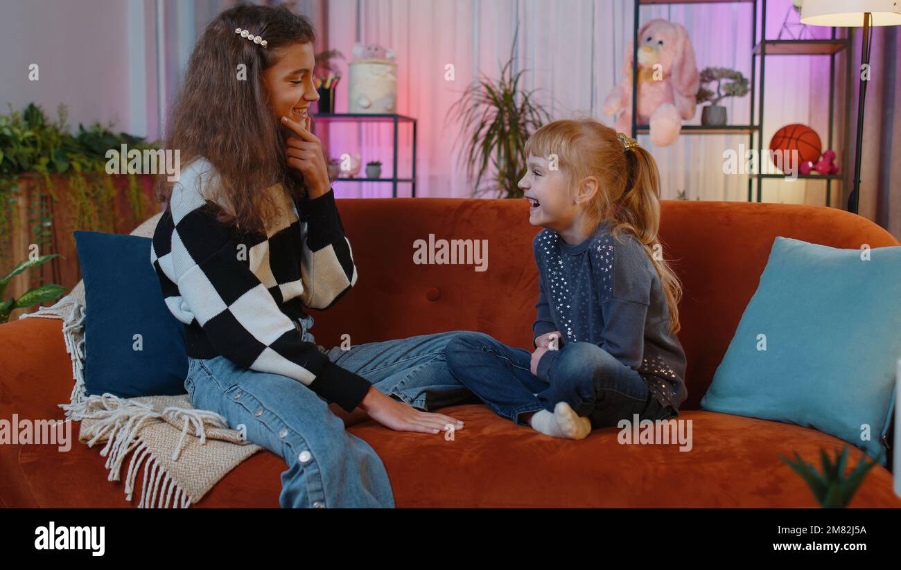 Teenage child and little sister kid talking, making friendly ...