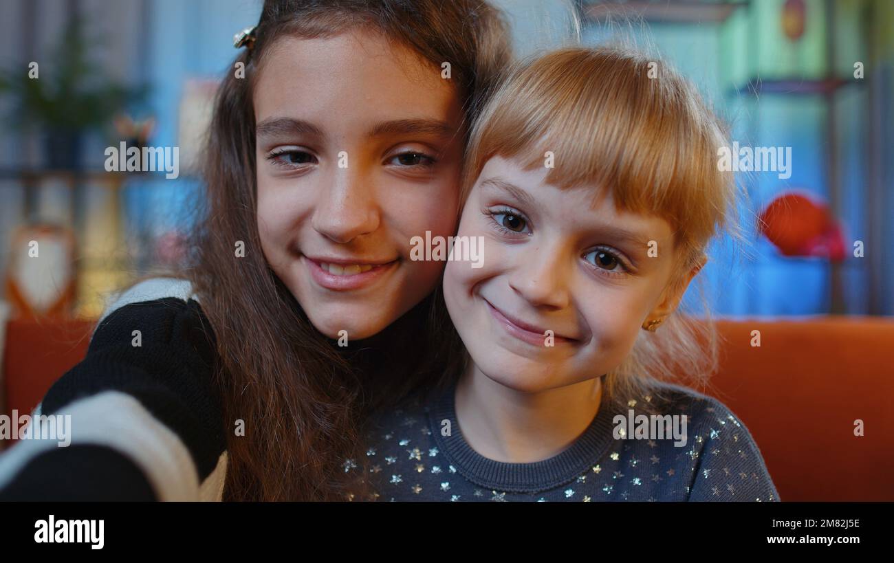 POV portrait of happy calm teenage and little sisters child kids ...