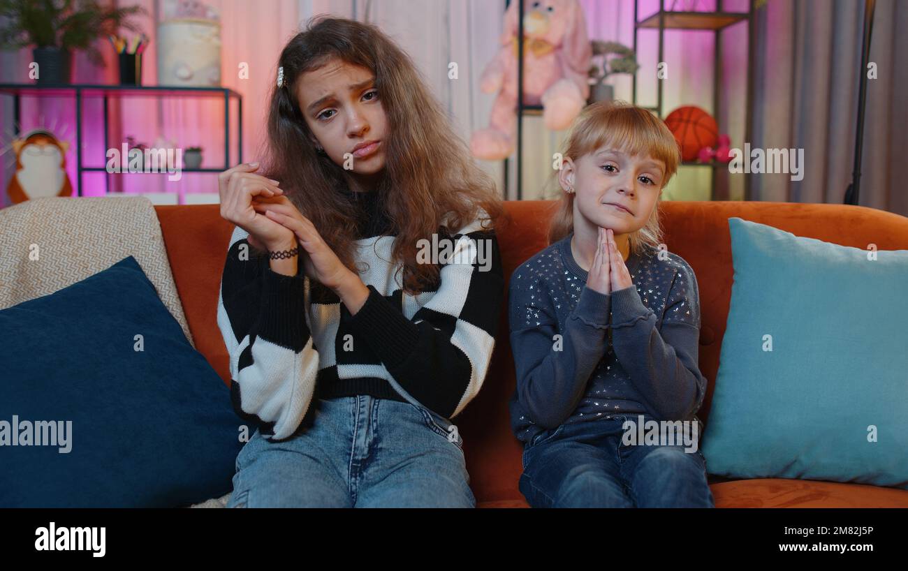 Child little sister kid girls praying sincerely with folded arms ...
