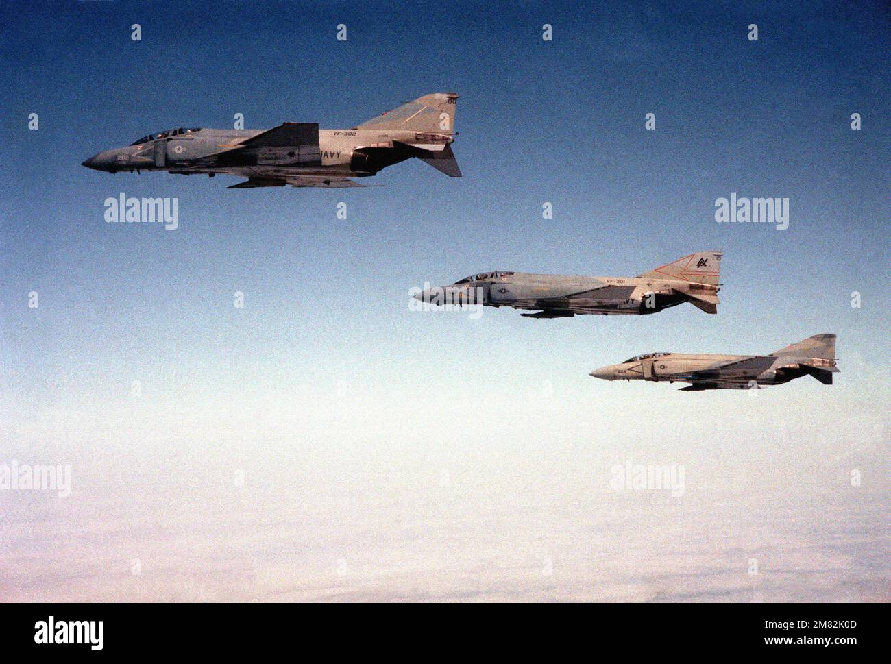 An air-to-air left side view of two F-4S Phantom II aircraft. They are ...
