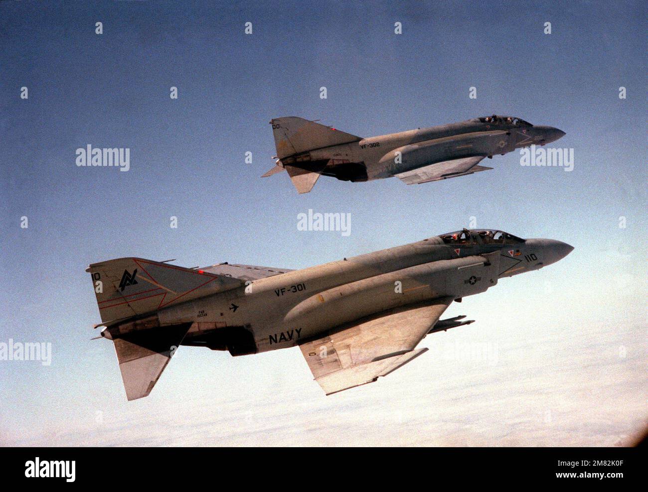 An air-to-air right side view of two F-4S Phantom II aircraft. They are ...