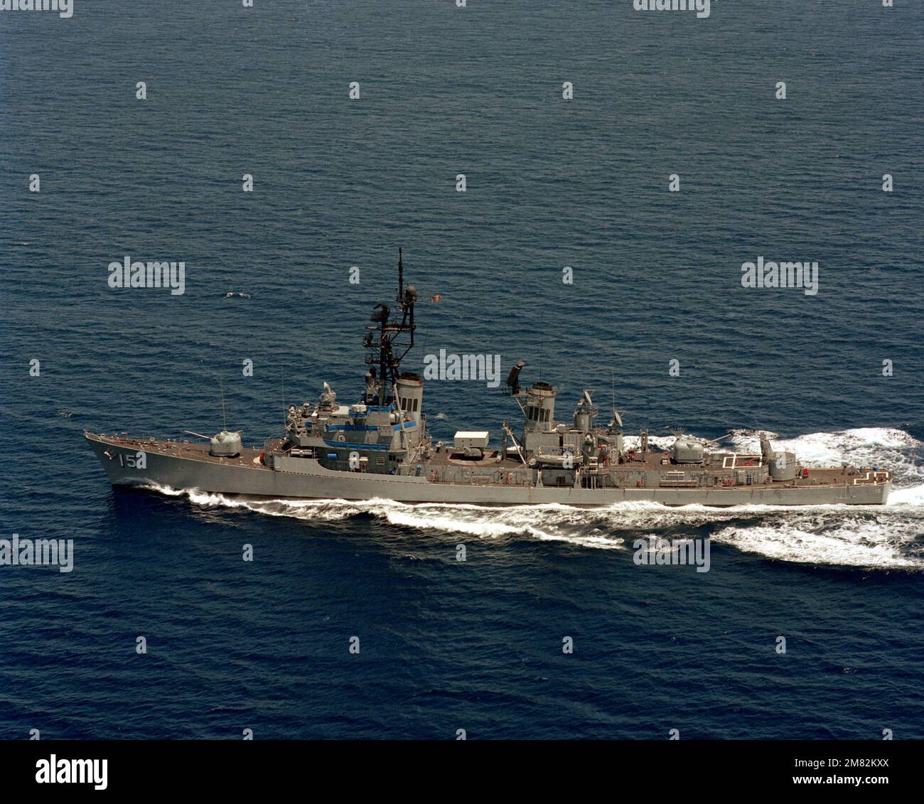 Aerial port beam view of the Charles F. Adams class guided missile ...