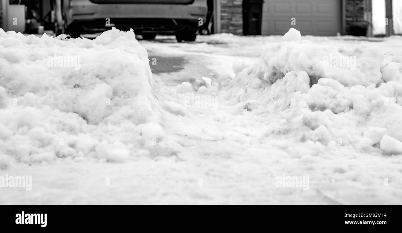 Snowbank at the end of a driveway left after city snowplows cleared a ...
