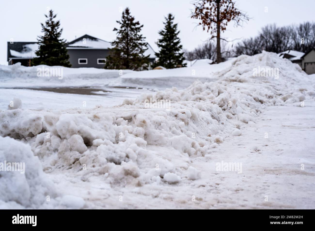 Snowbank at the end of a driveway left after city snowplows cleared a ...