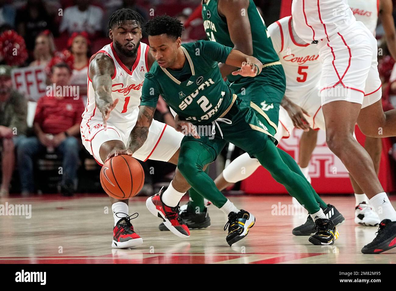 Houston's Jamal Shead (1) tries to steal the ball from South Florida's ...